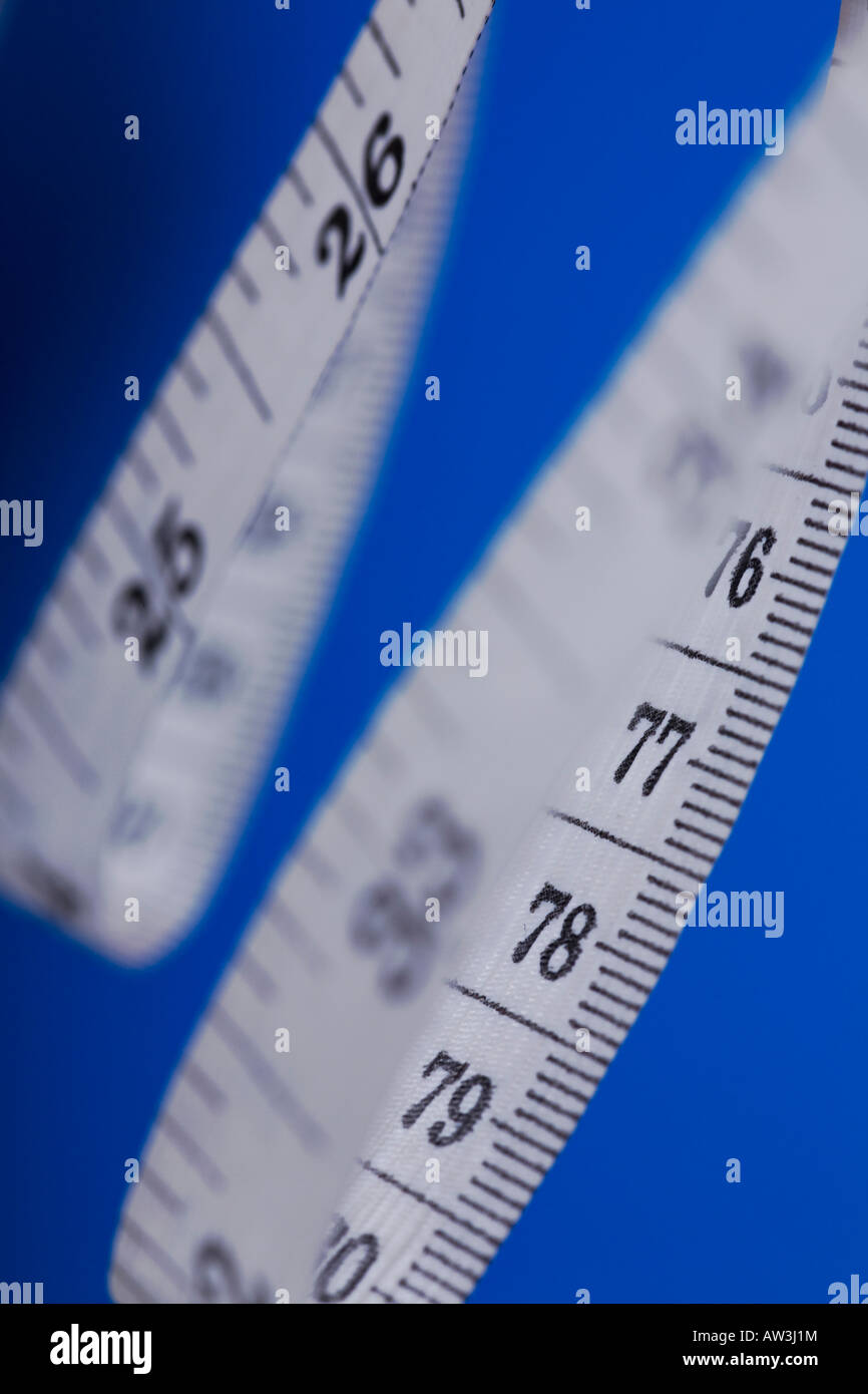 Measurement tape roll displaying inches and centimeters Stock Photo - Alamy