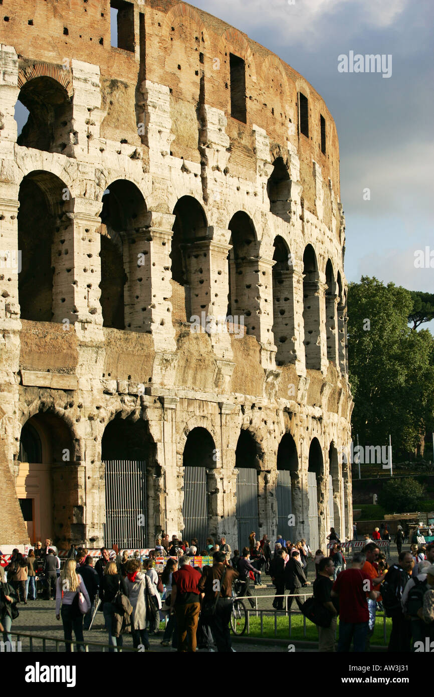 Tourists crowd around the entrance to the famous Colosseum monument ...