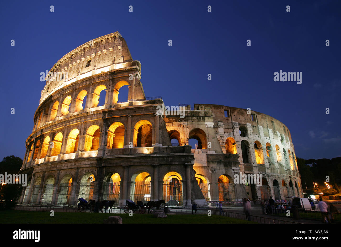 The Colosseum in Rome, illuminated at night twilight, a popular Italian ...