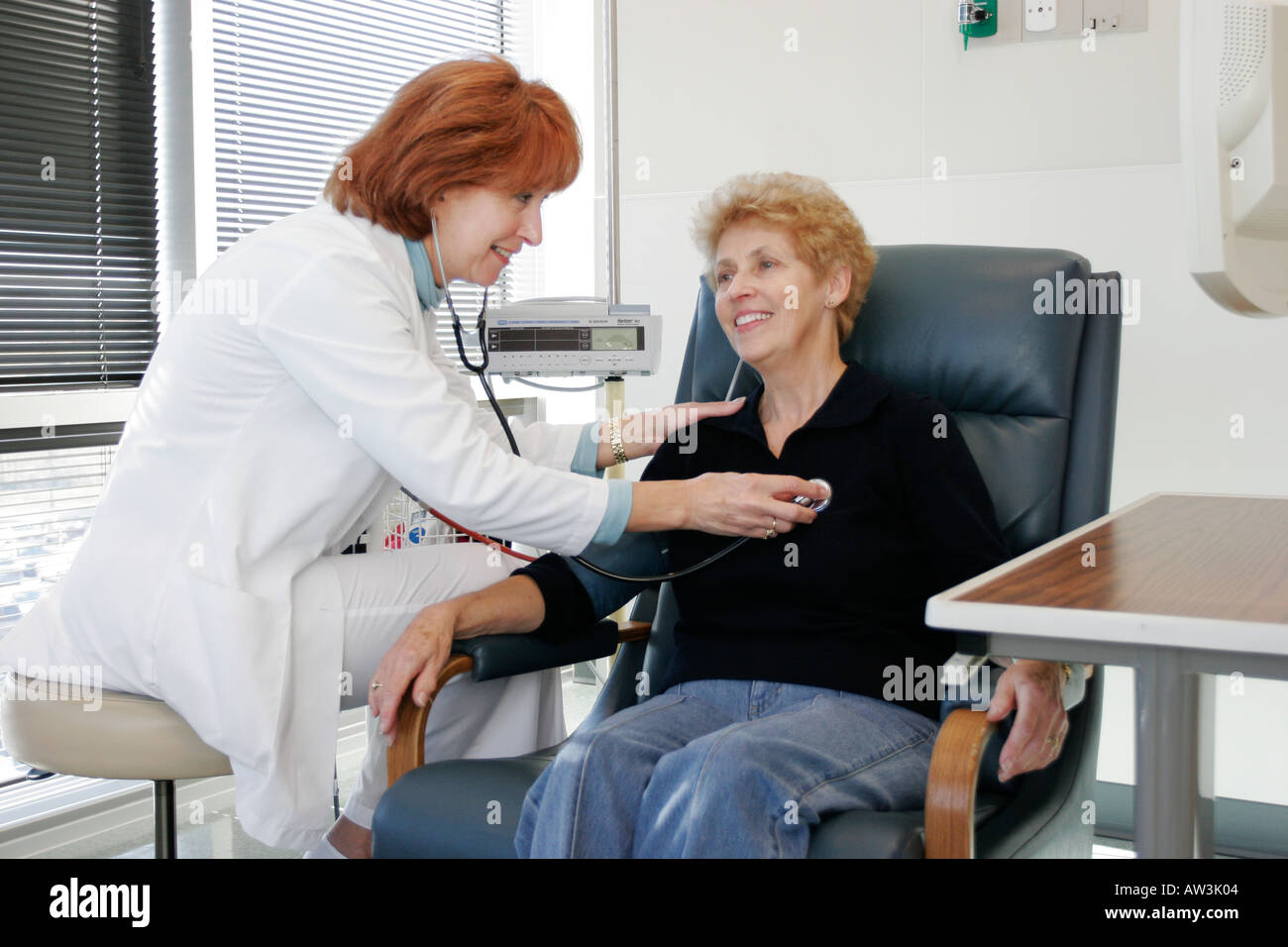 nurse listening to patient's heart Stock Photo - Alamy
