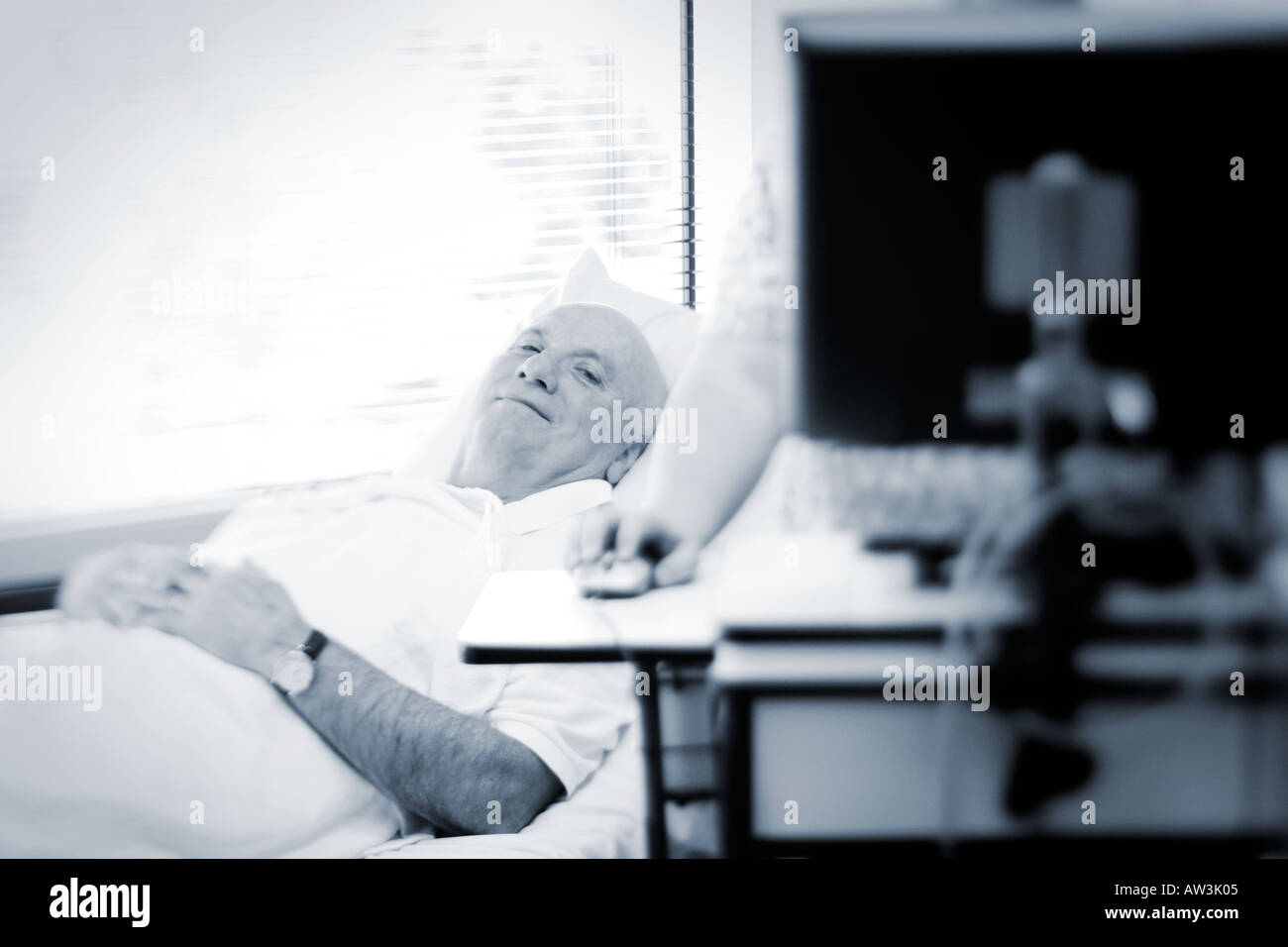hospital patient looks toward nurse and computer screen Stock Photo - Alamy