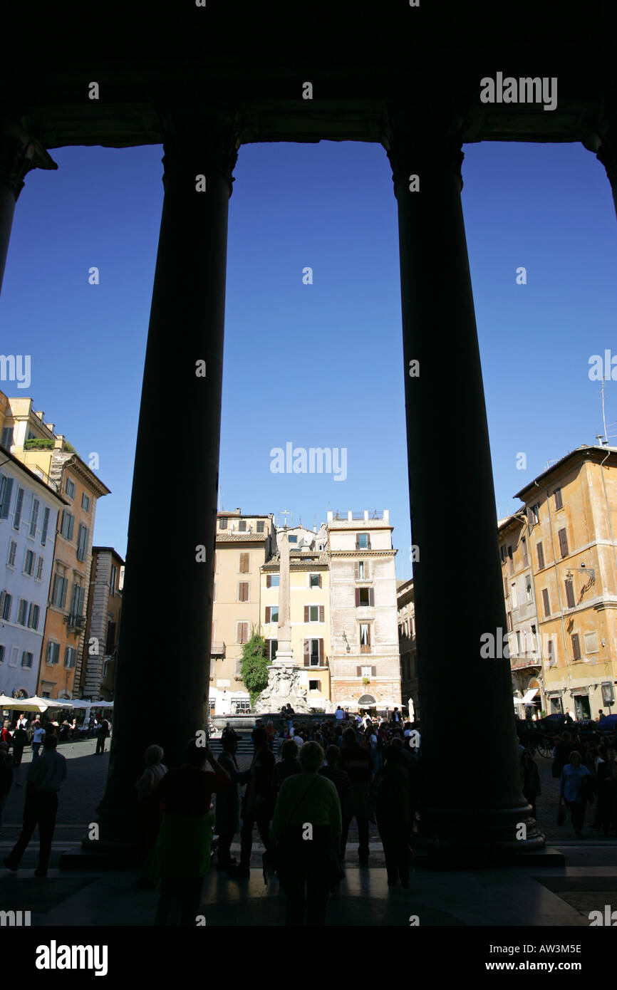 Tourists enter the famous ancient Pantheon building between corinthian ...