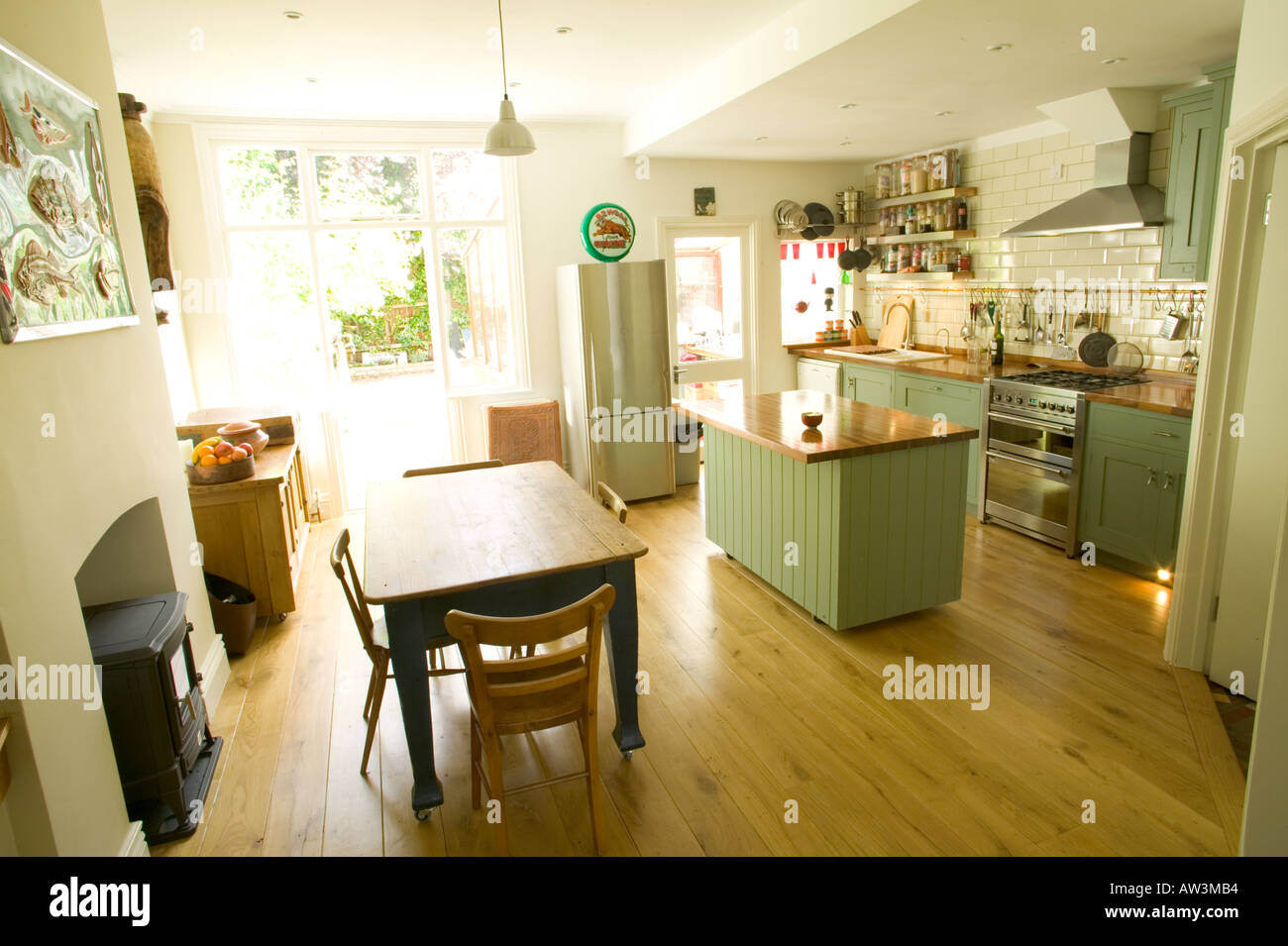 Contemporary sunlit kitchen with wooden floor and furnishings Stock ...