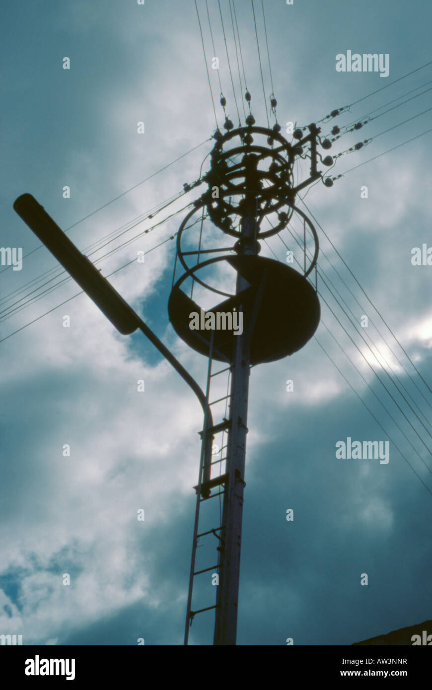 Old telephone distribution pole, with lamp, access ladder and platform ...