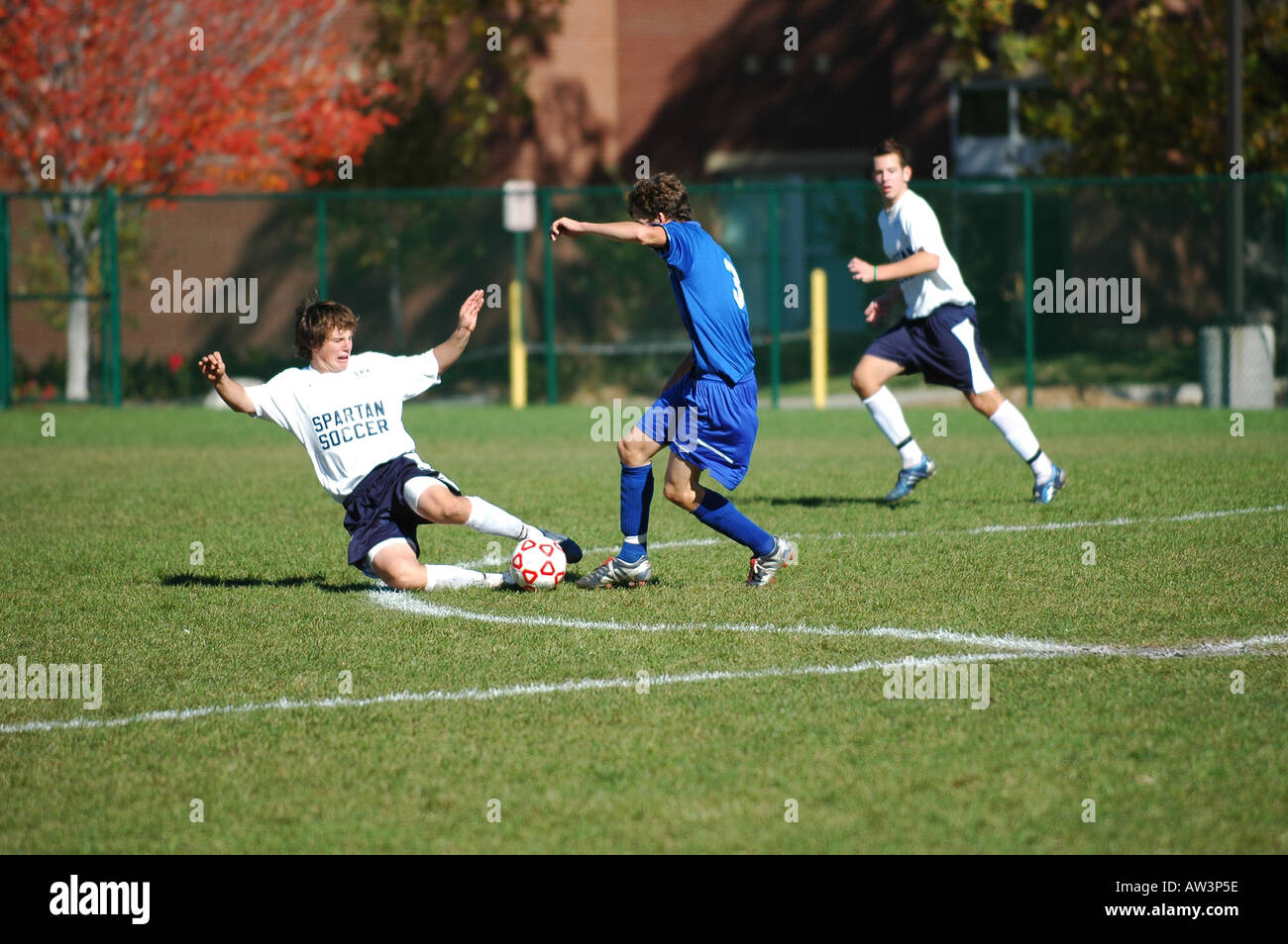 High school soccer player kicking the ball Stock Photo - Alamy