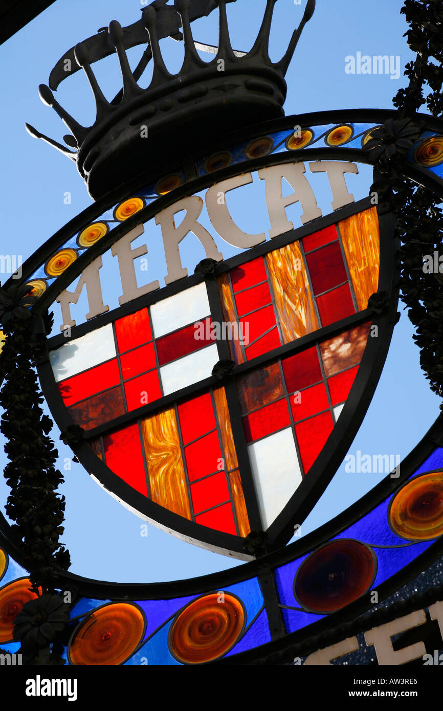 Stained glass and wrought iron crest hanging from arch at entrance to ...