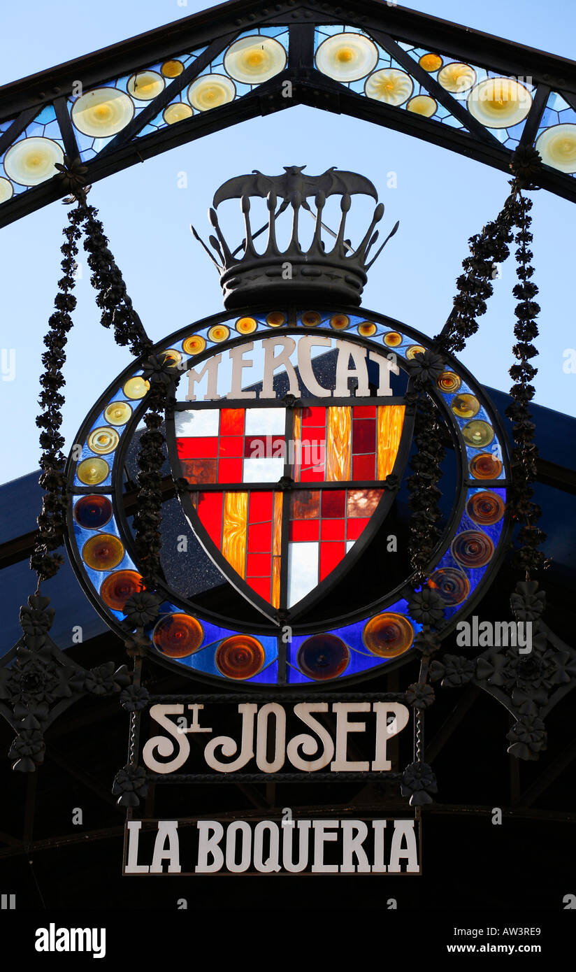 Stained glass and wrought iron crest hanging from arch at entrance to ...