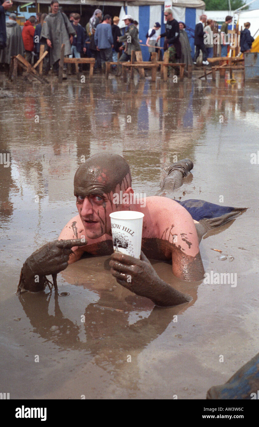 glastonbury 1998 man laying in mud enjoying cider from the cider bus ...