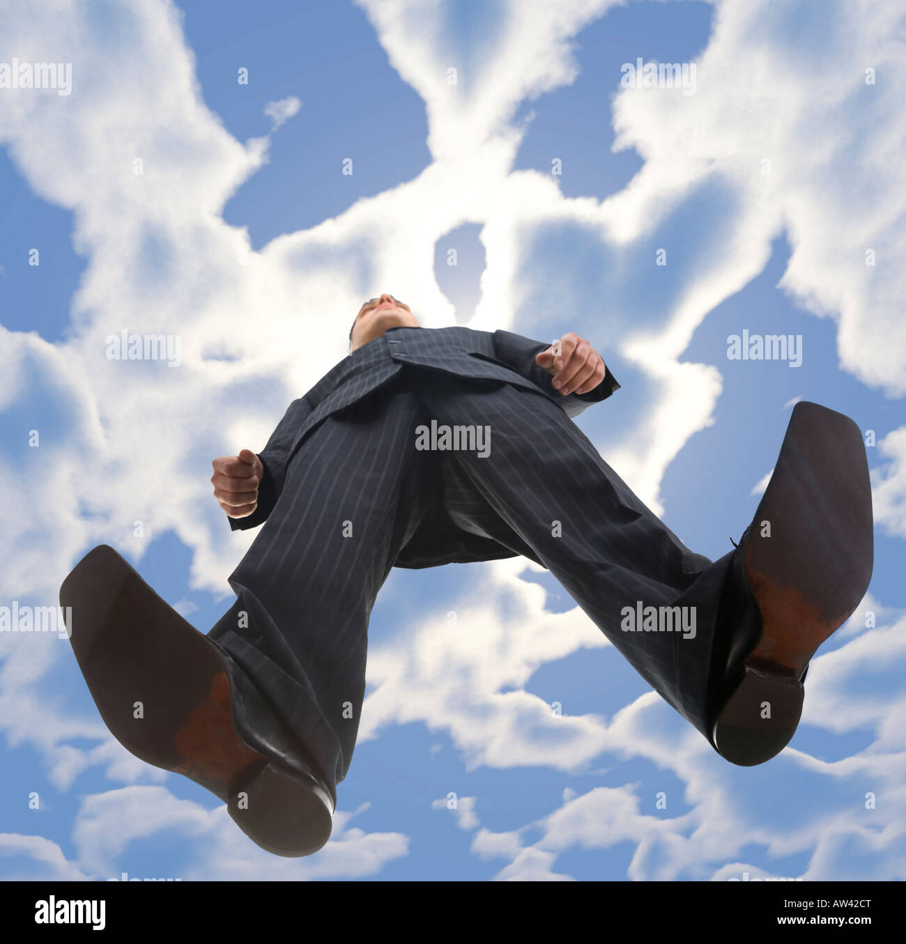 Young serious businessman standing in suit Low angle view Stock Photo ...