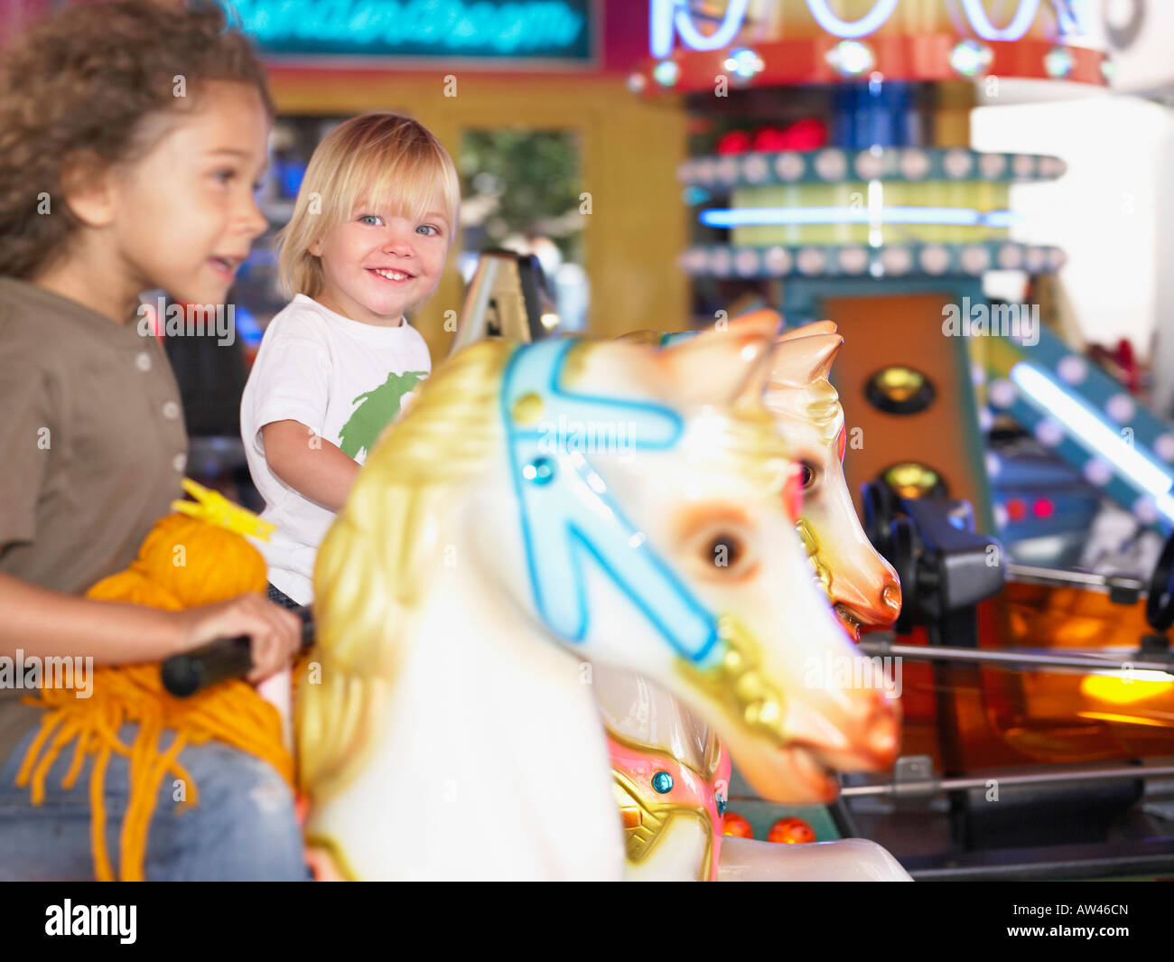 Little girls on merry go round Stock Photo - Alamy