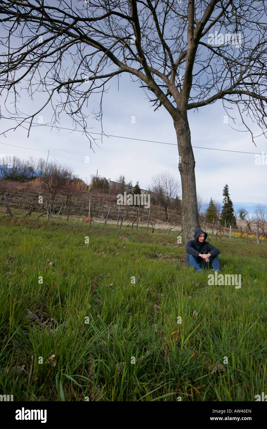 Boy against a tree Stock Photo - Alamy