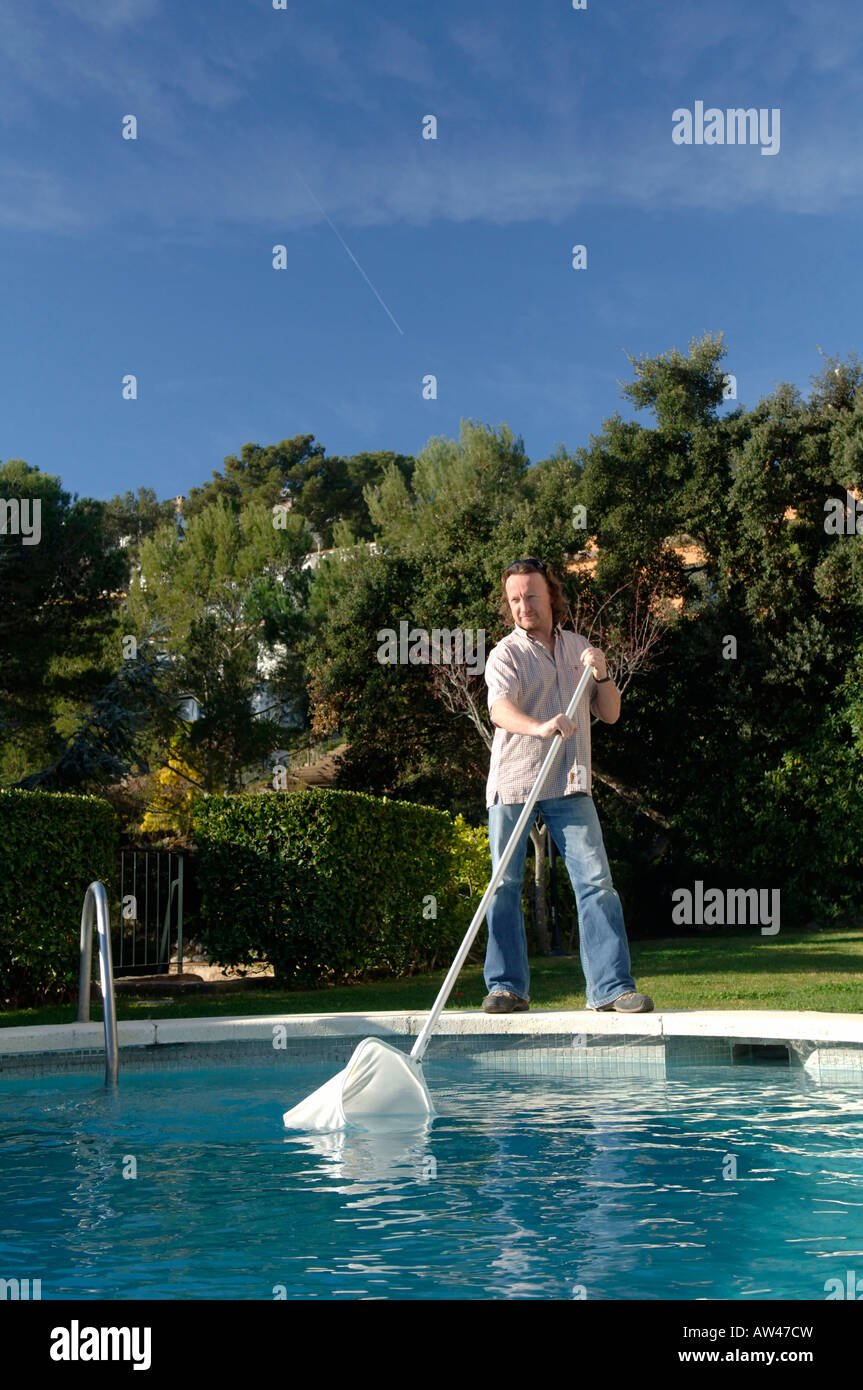 Man cleaning swimming pool Stock Photo - Alamy