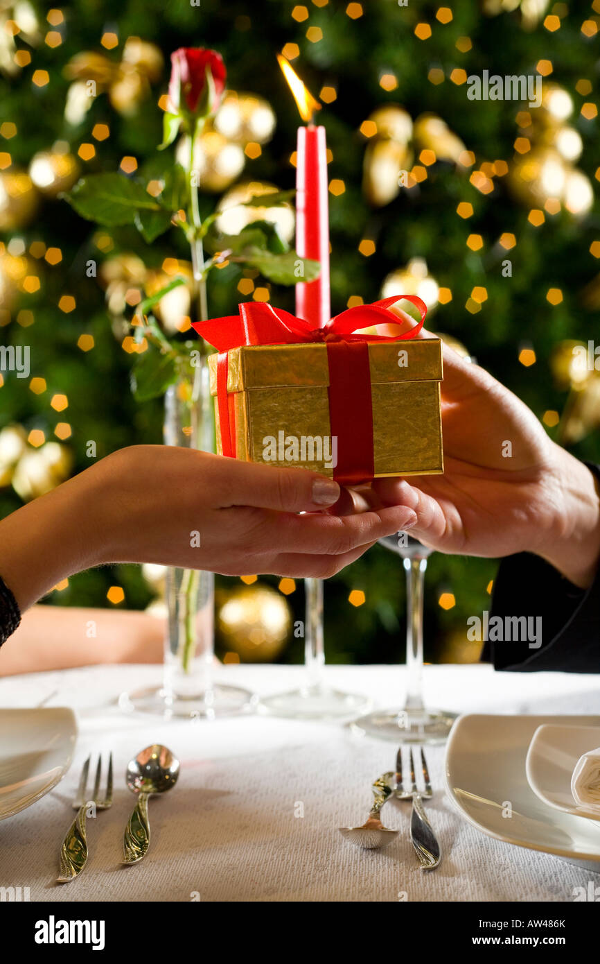 Couple during dinner party They giving each other a present Close up on ...