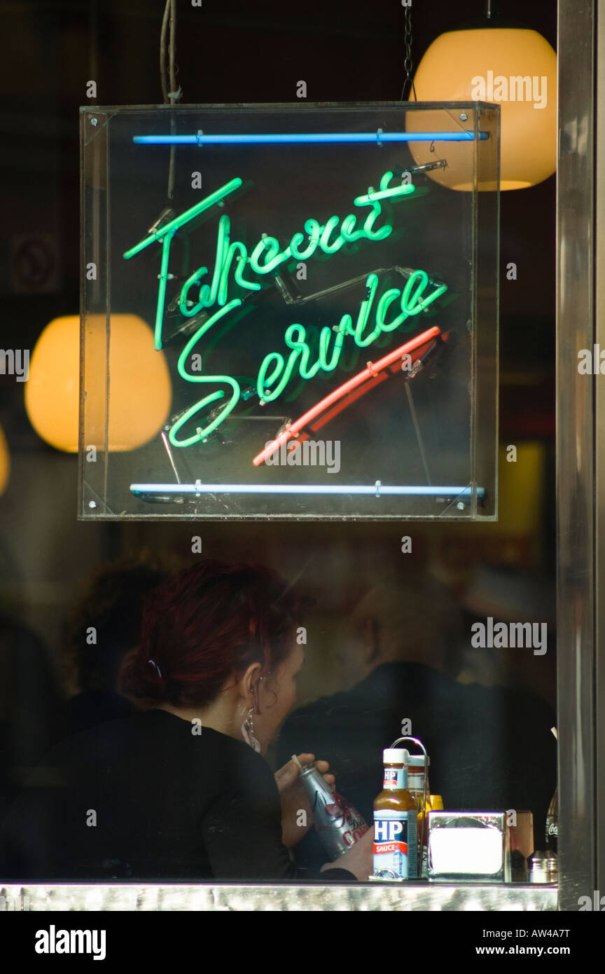 a diner window showing Takeout sign and a girl Stock Photo - Alamy