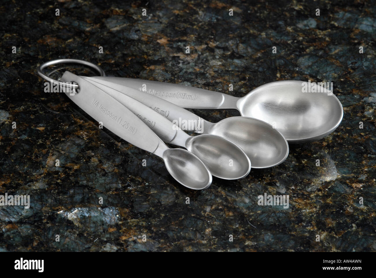 Measuring spoons on a granite surface Stock Photo - Alamy