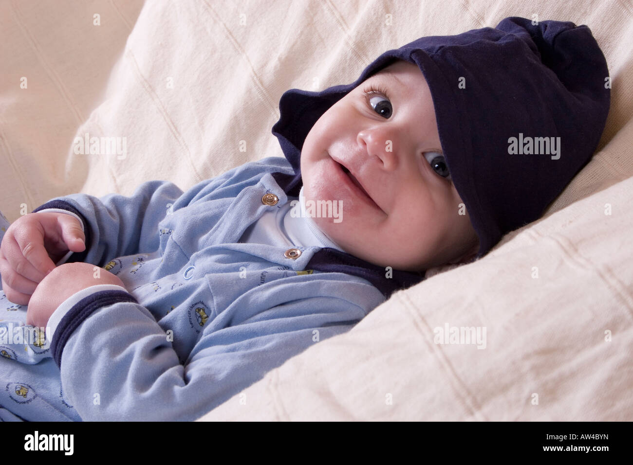 portrait cute baby boy in hooded babygro smiling Stock Photo - Alamy
