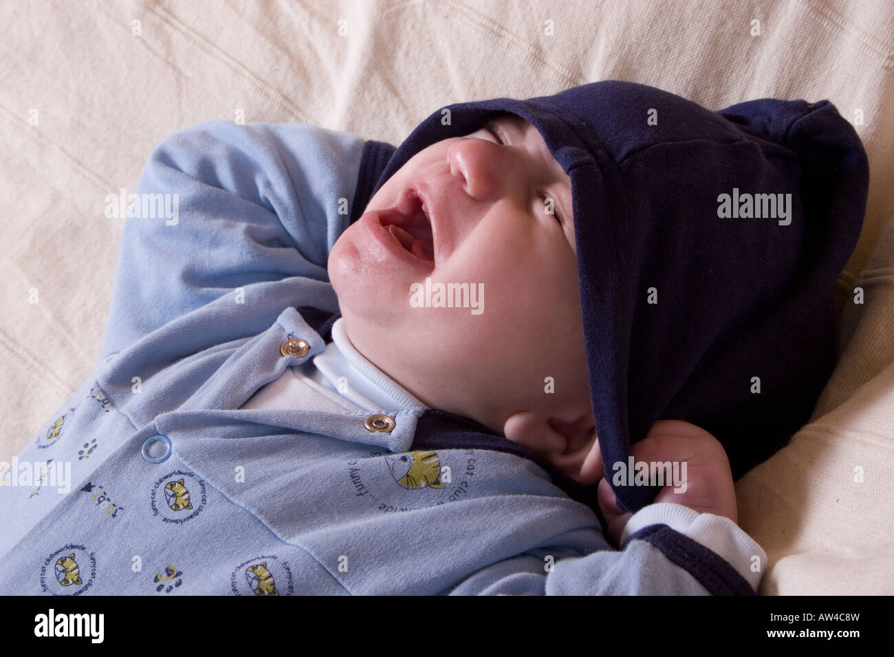 little baby in blue babygro screaming loud Stock Photo - Alamy
