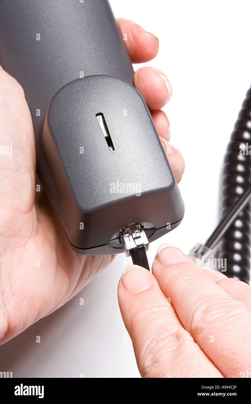 Hands assembling a phone receiver and its curly cord Stock Photo - Alamy