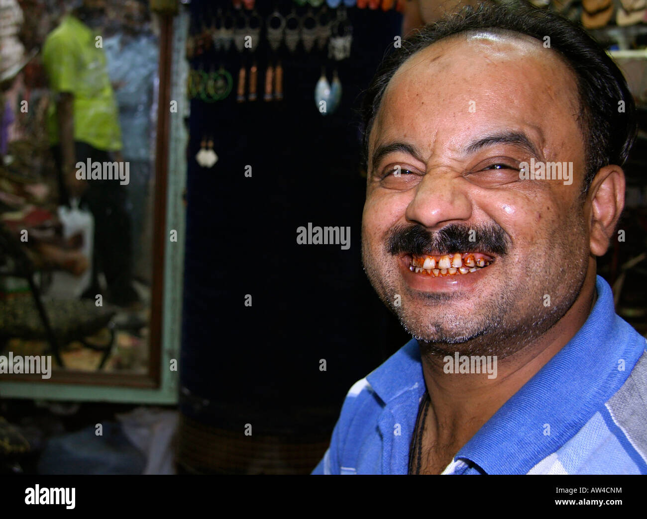 salesman showing off his stained teeth delhi india Stock Photo - Alamy