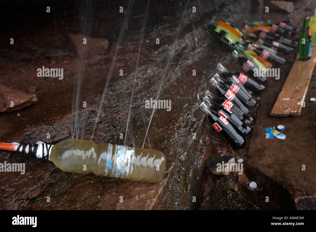 Improvised cooling spray made from a punctured plastic bottle and pipe ...