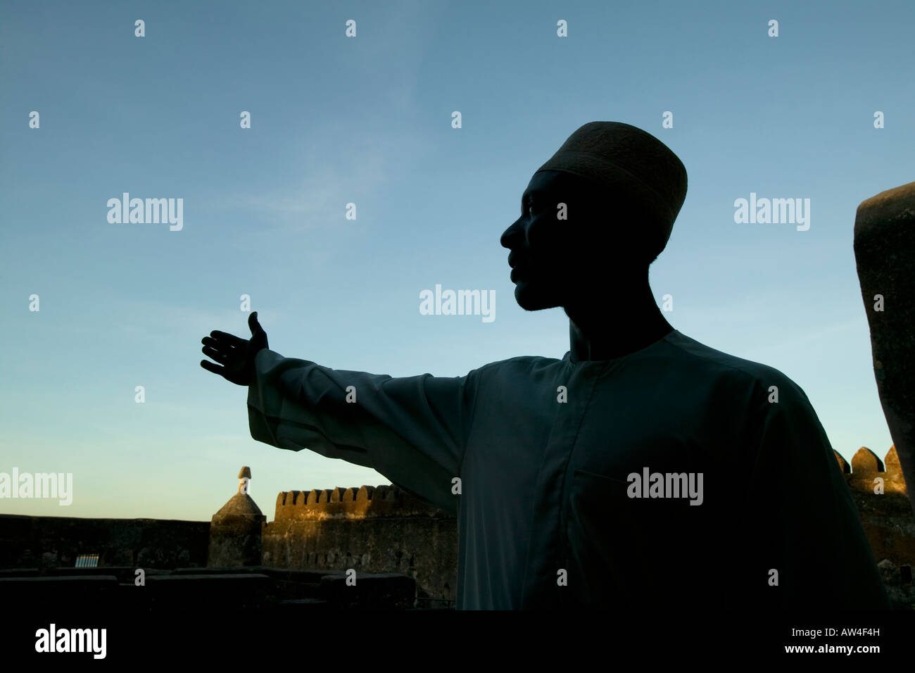 Africa Kenya Mombasa Setting sun silhouettes tour guide inside Fort ...