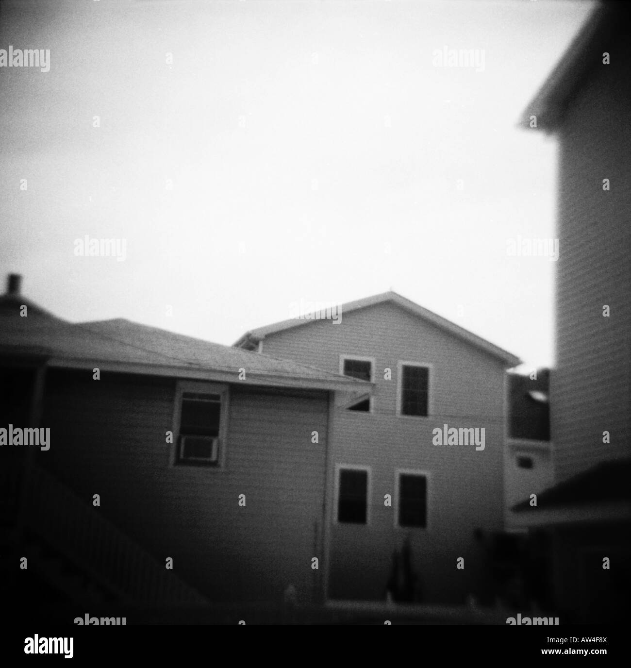 generic houses crowded together with black windows Stock Photo - Alamy