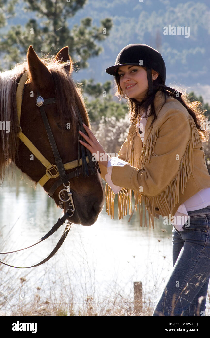 beautiful young model posing with her horse Stock Photo - Alamy