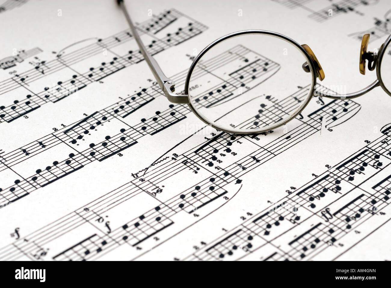 Old reading glasses resting on old sheet music Stock Photo - Alamy