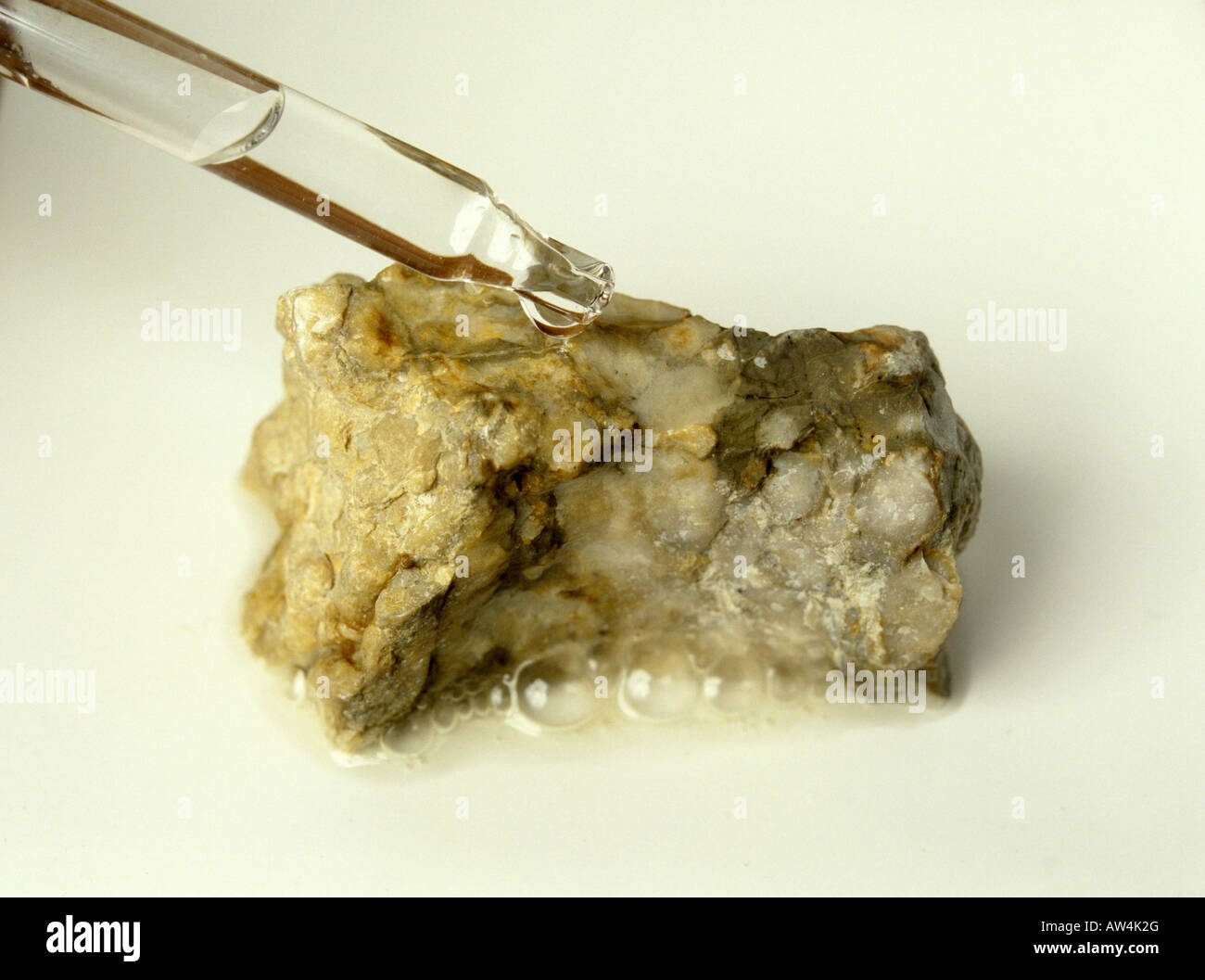 Acid reacting with a piece of rock generates carbon dioxide Stock Photo ...