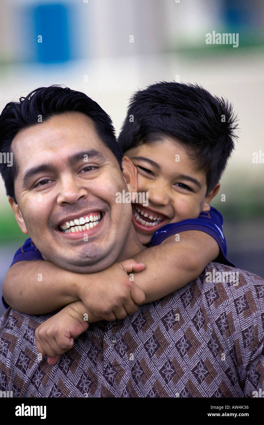 Hispanic boy hugging father Stock Photo - Alamy