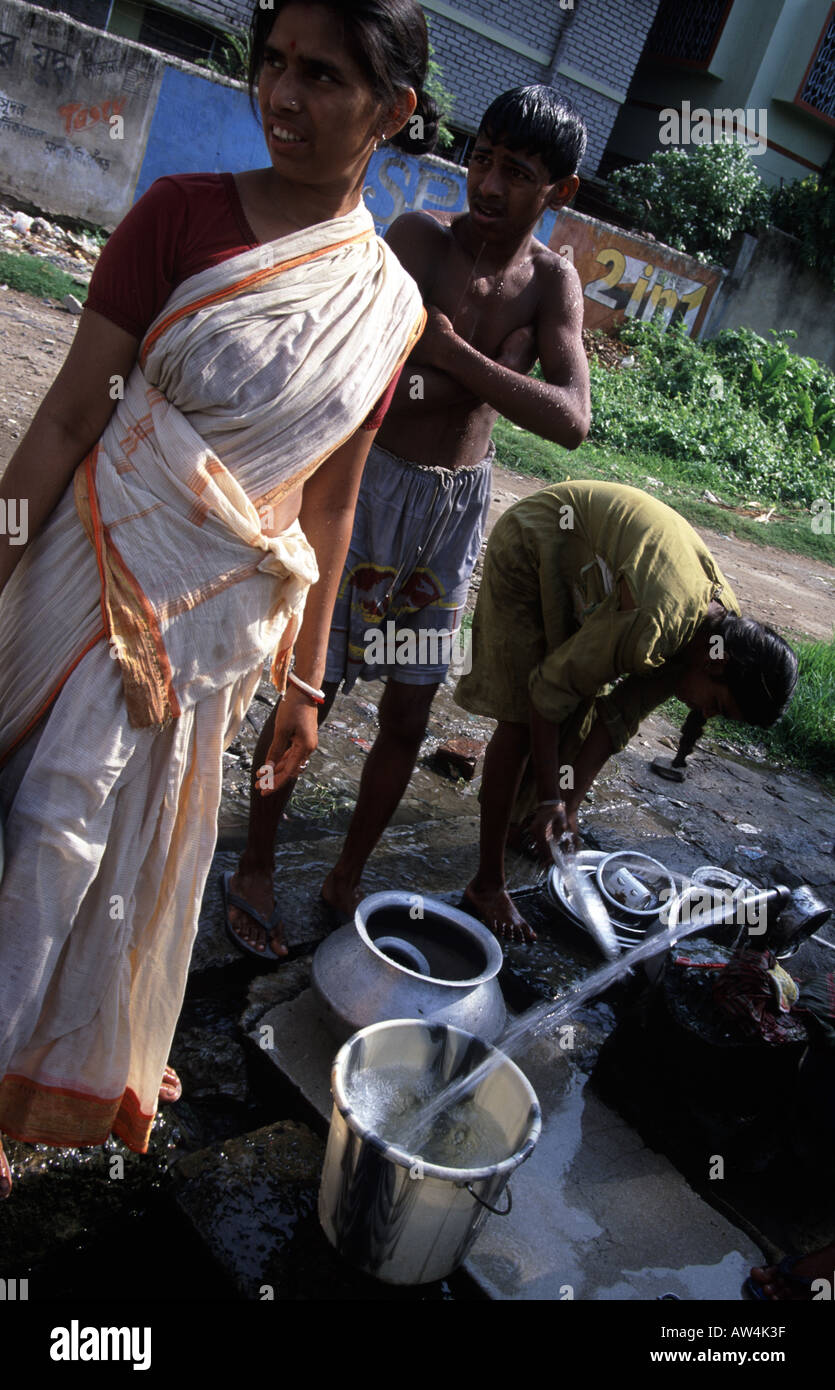 Family using water from a broken standpipe, Kolkata, formerly Calcutta ...