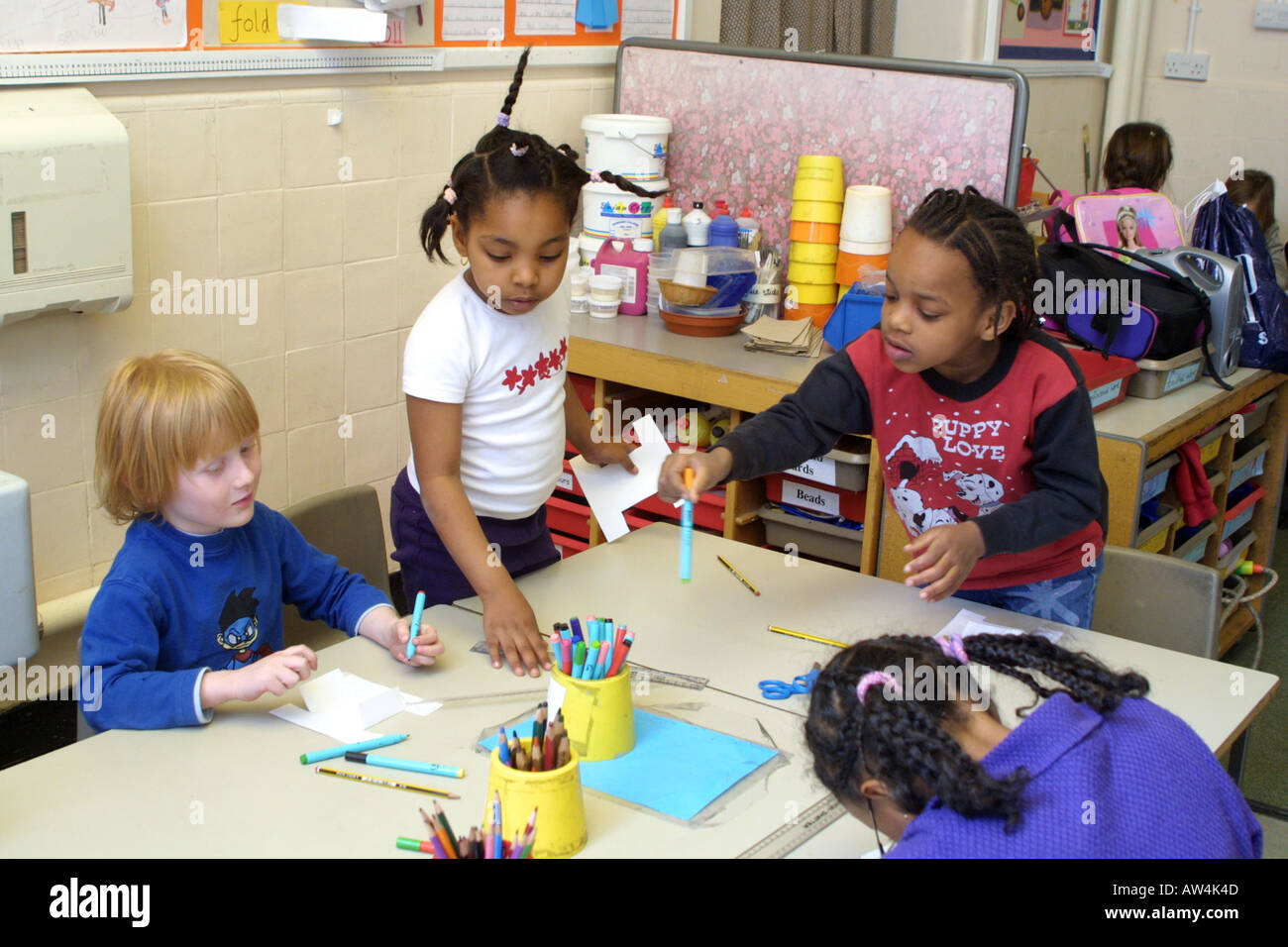 primary school children in a classroom drawing Stock Photo - Alamy
