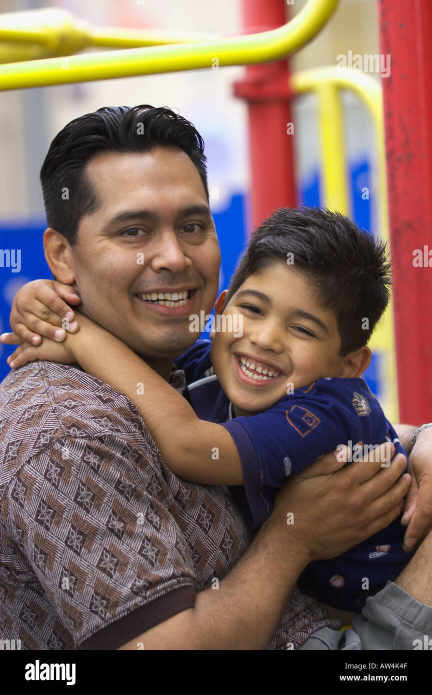 Hispanic father and son hugging Stock Photo - Alamy
