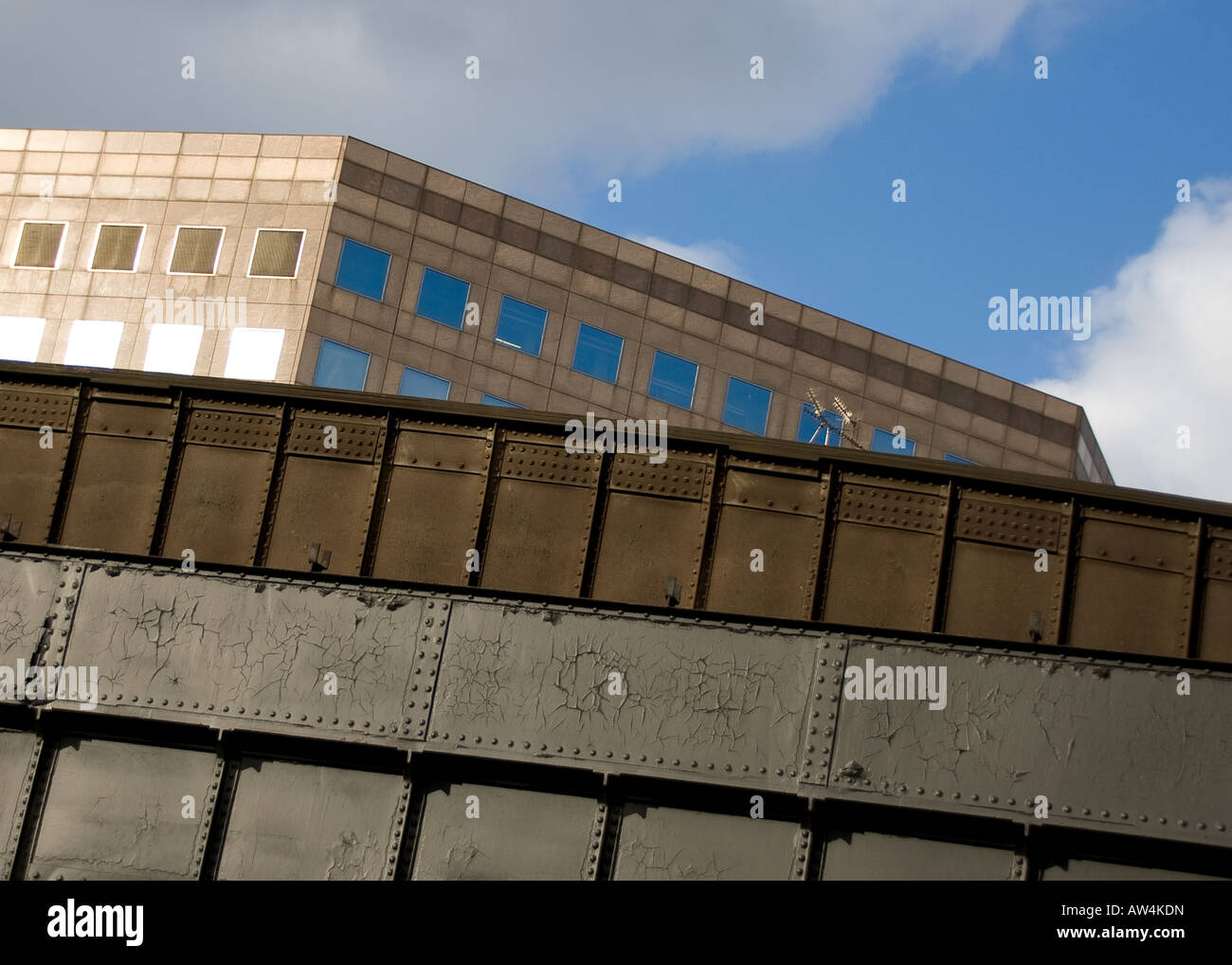 architectural railway bridge with modern square building behind, london ...