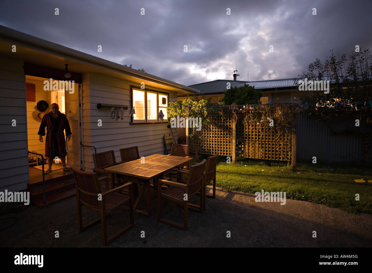Man outside house night hi-res stock photography and images - Alamy