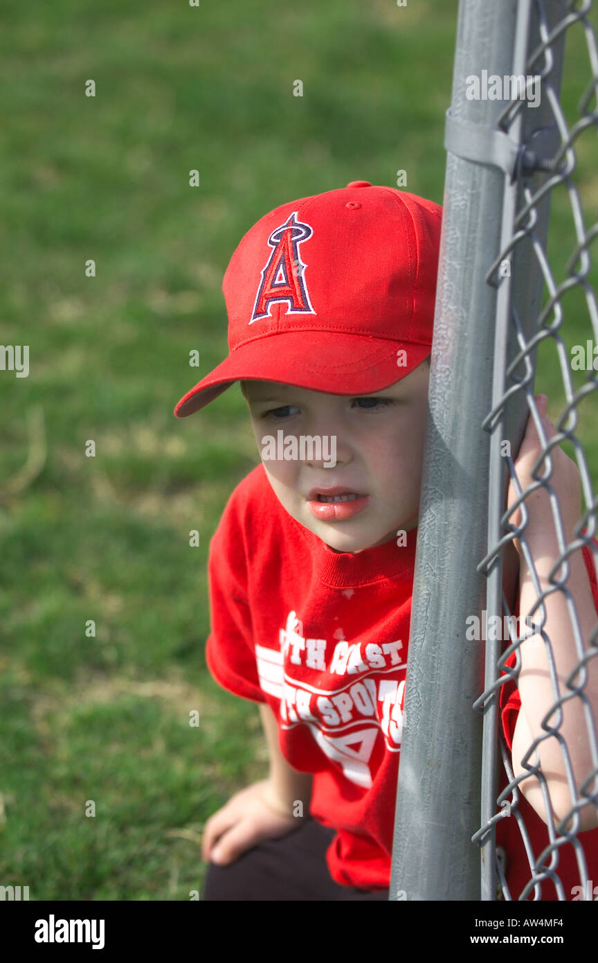 baseball boy watching with concerned look Stock Photo - Alamy