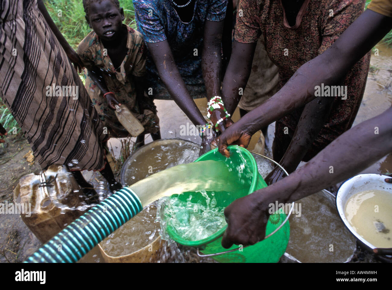 Sudanese refugees getting potable water at a well in western Ethiopia ...