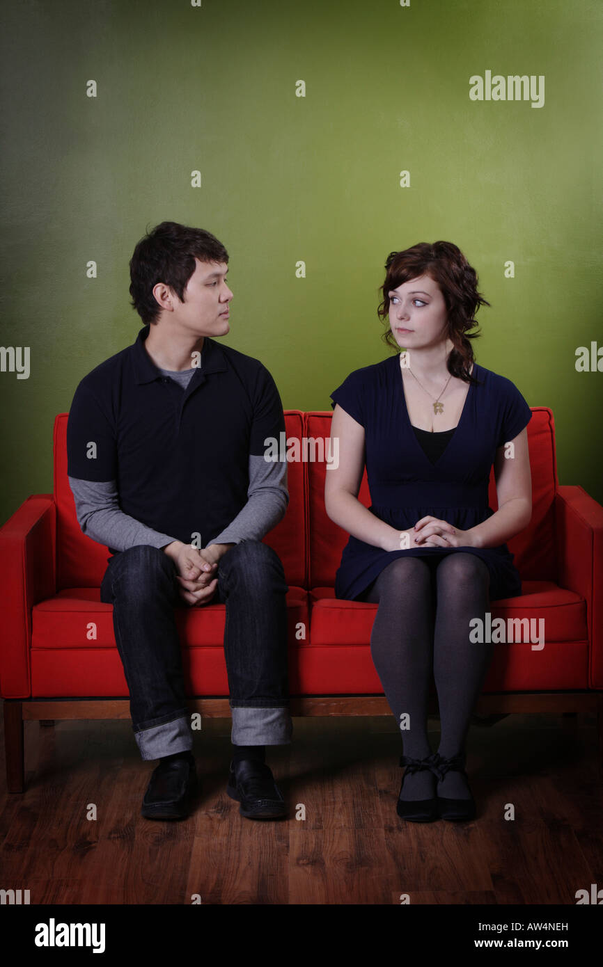A couple sitting on a couch Stock Photo - Alamy
