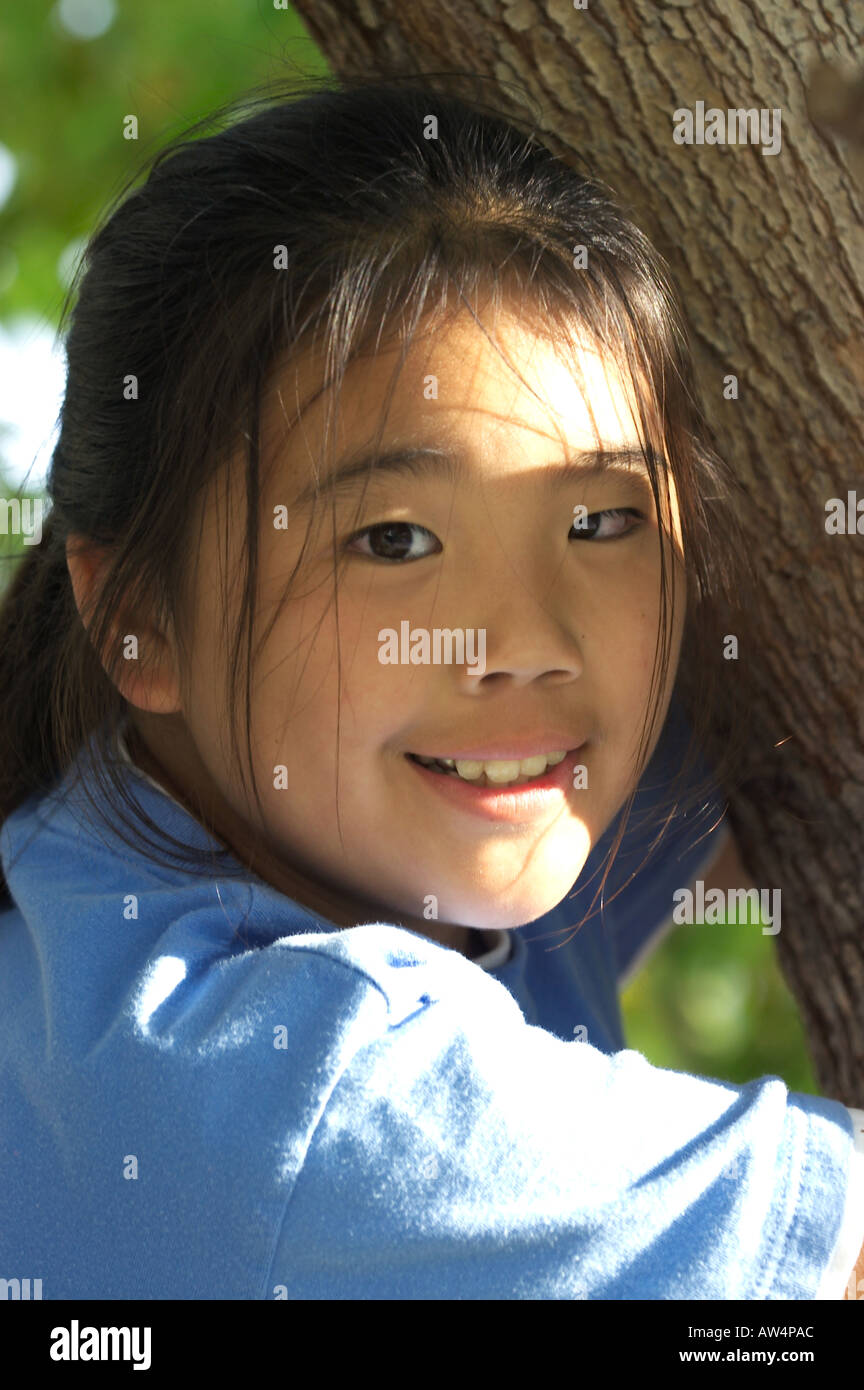 Asian girl by tree Stock Photo - Alamy