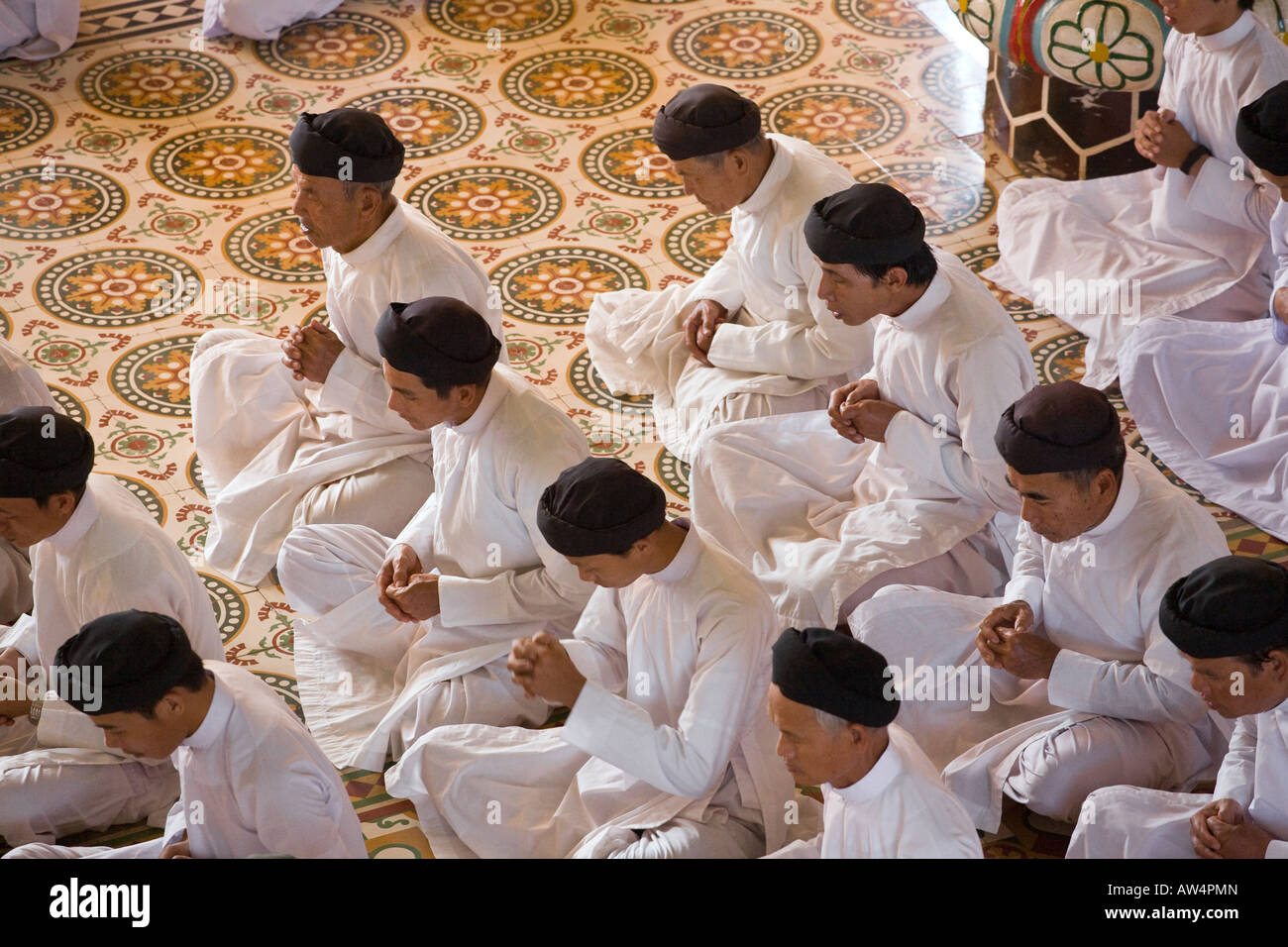 Lay worshipers during a prayer ceremony inside the CAO DAI GREAT TEMPLE ...