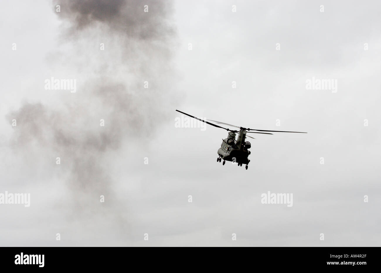 RAF Chinook HC2 helicopter flying through bomb smoke Stock Photo - Alamy