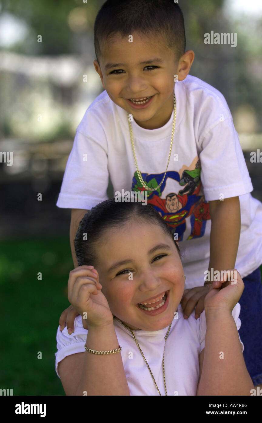 Hispanic brother and sister laughing Stock Photo - Alamy