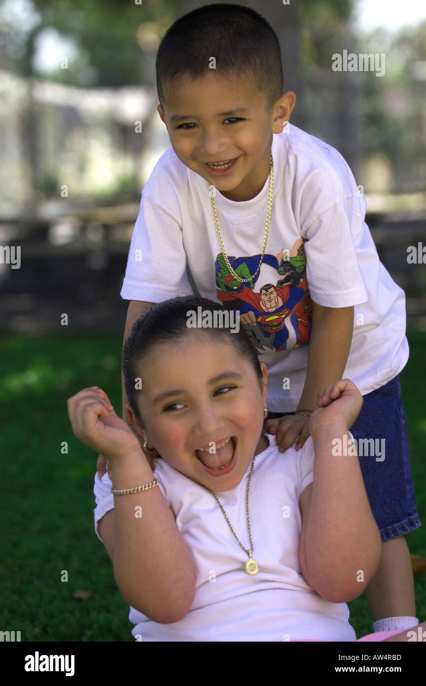 Hispanic brother and sister playing together Stock Photo - Alamy