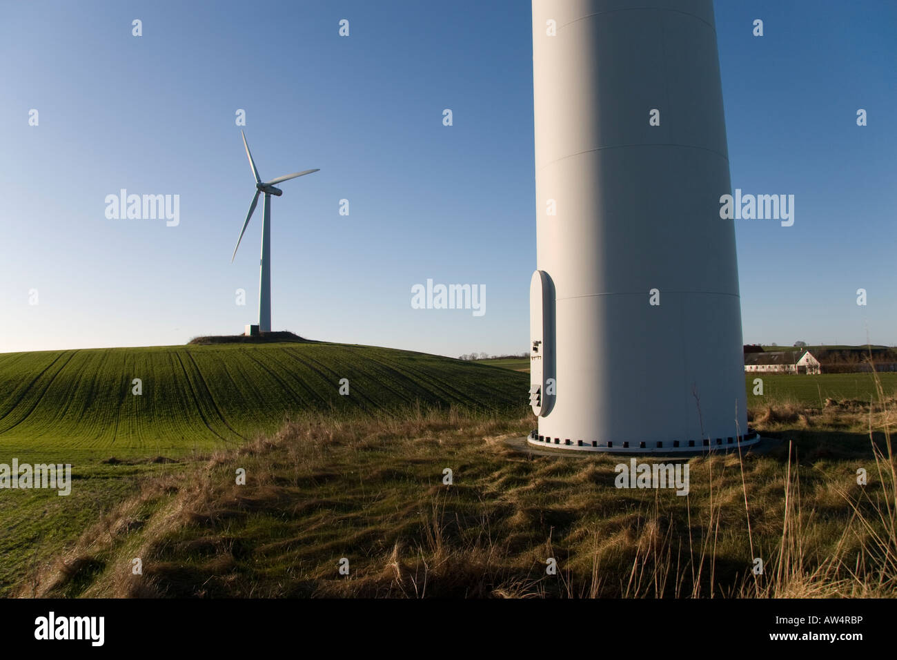 Modern windmill in field, blue sky Stock Photo - Alamy