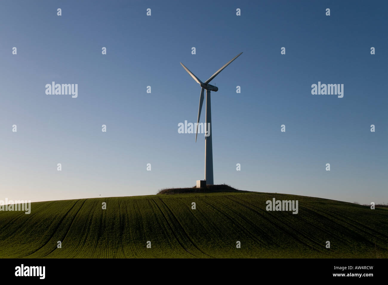 Modern windmill in field, blue sky Stock Photo - Alamy