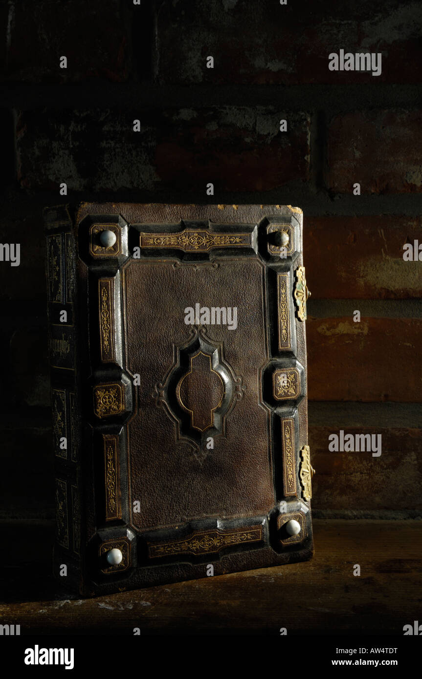 Ancient book illuminated in darkness Stock Photo - Alamy