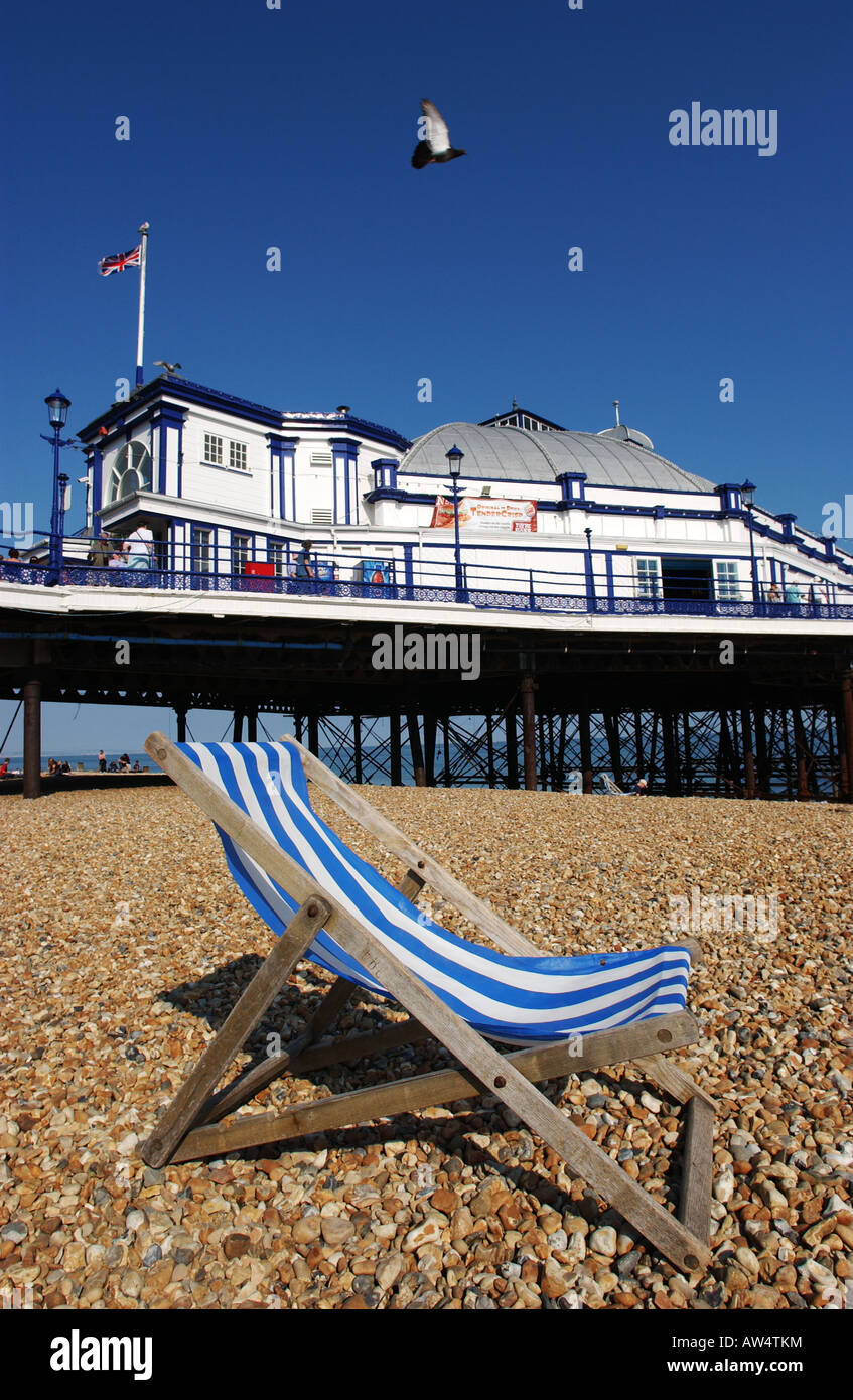 A blue and white deck chair on Eastbourne's pebble beach with the world ...