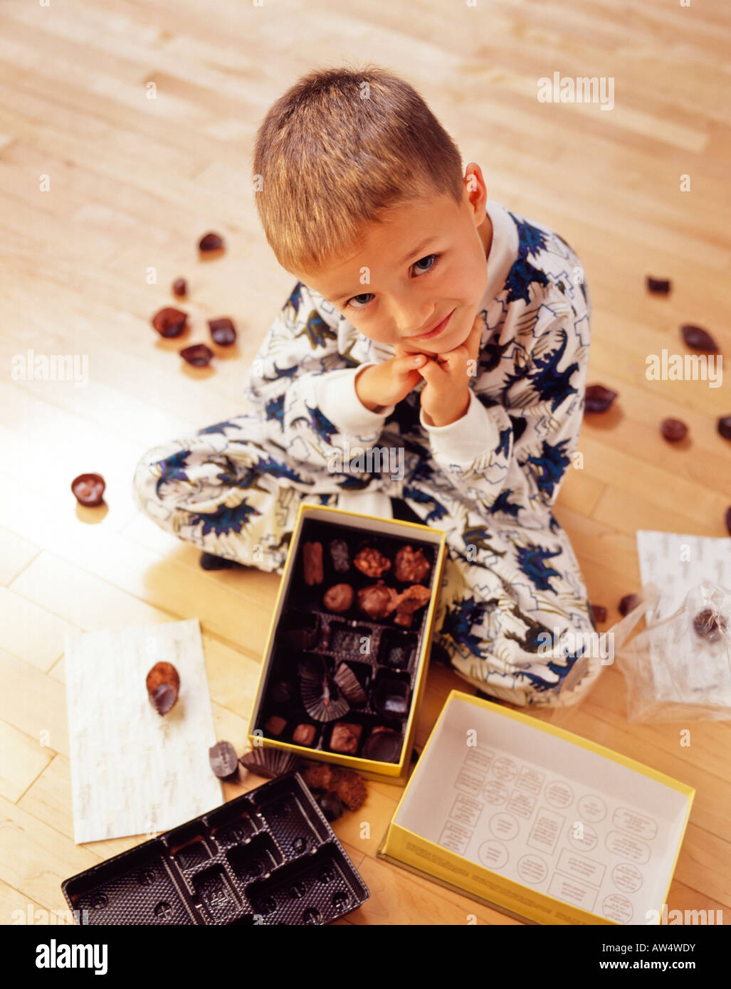 Boy into box of chocolates Stock Photo - Alamy