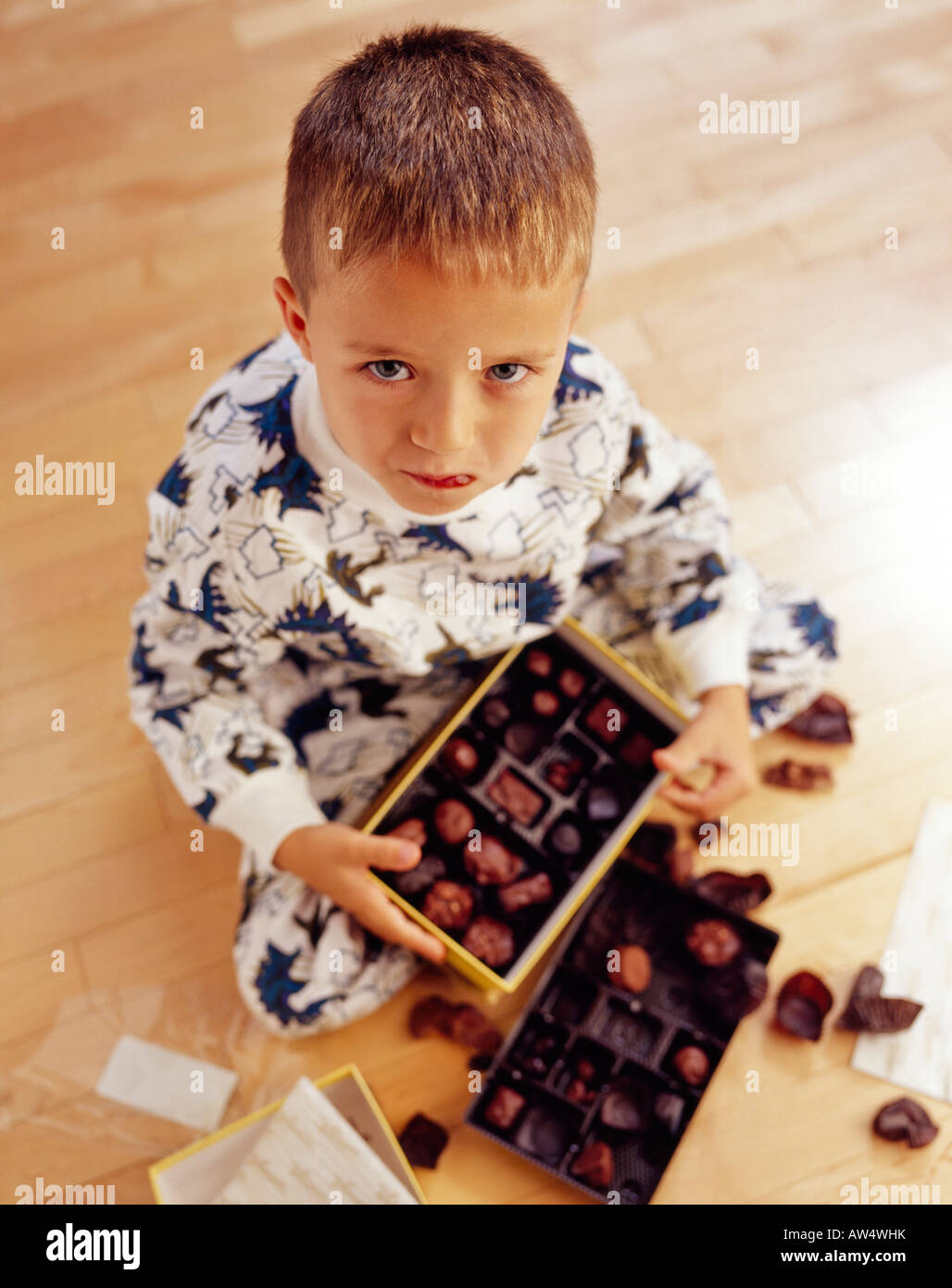 Boy into box of chocolates Stock Photo - Alamy
