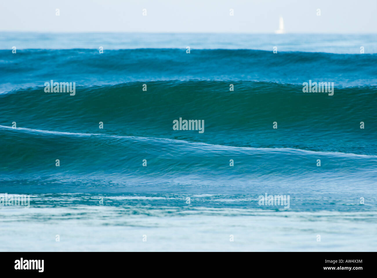 Waves in the ocean with a sail boat Stock Photo - Alamy